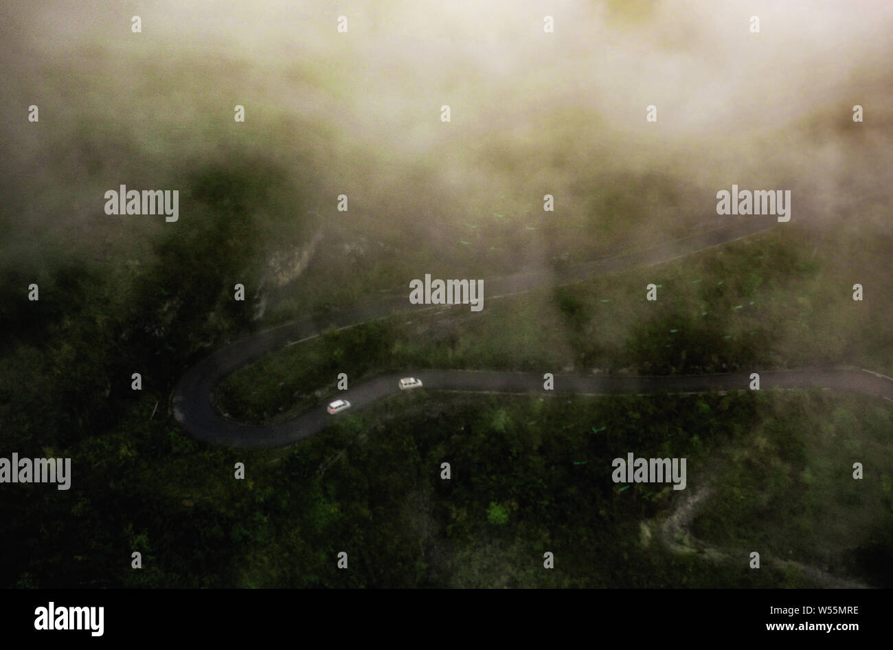 View of the mountain road in cloud and mist at Qibainong National ...