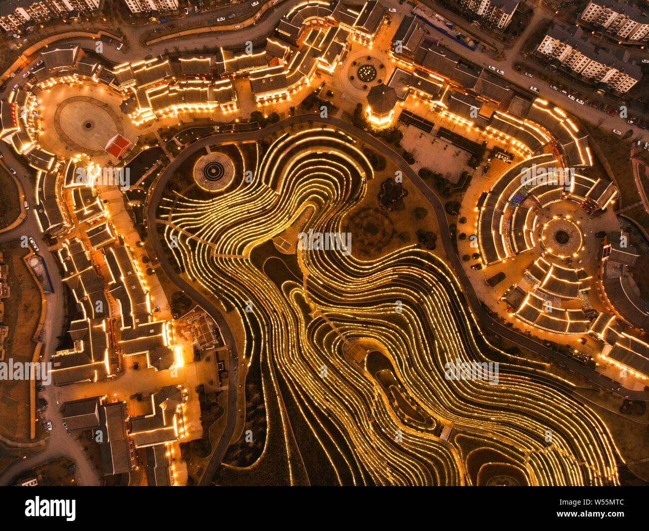 Aerial view of terraced rice fields illuminated by lights in Shexiang ...