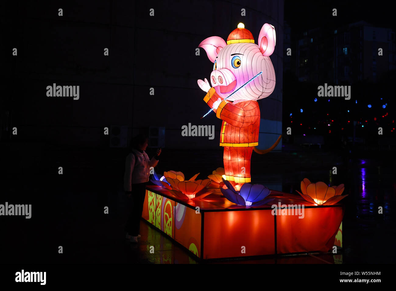 Local residents visit a pig-shaped lantern to mark the upcoming Spring ...