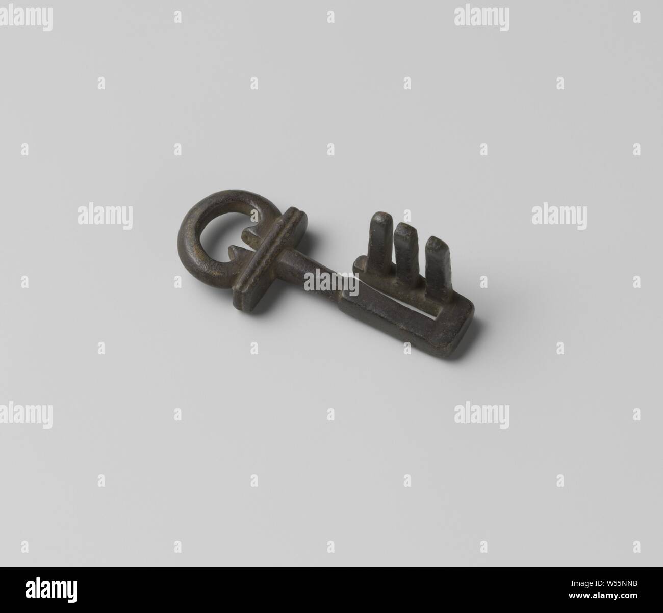 Key, Key with bow-shaped eye on flat square-shaped key chest. The ...