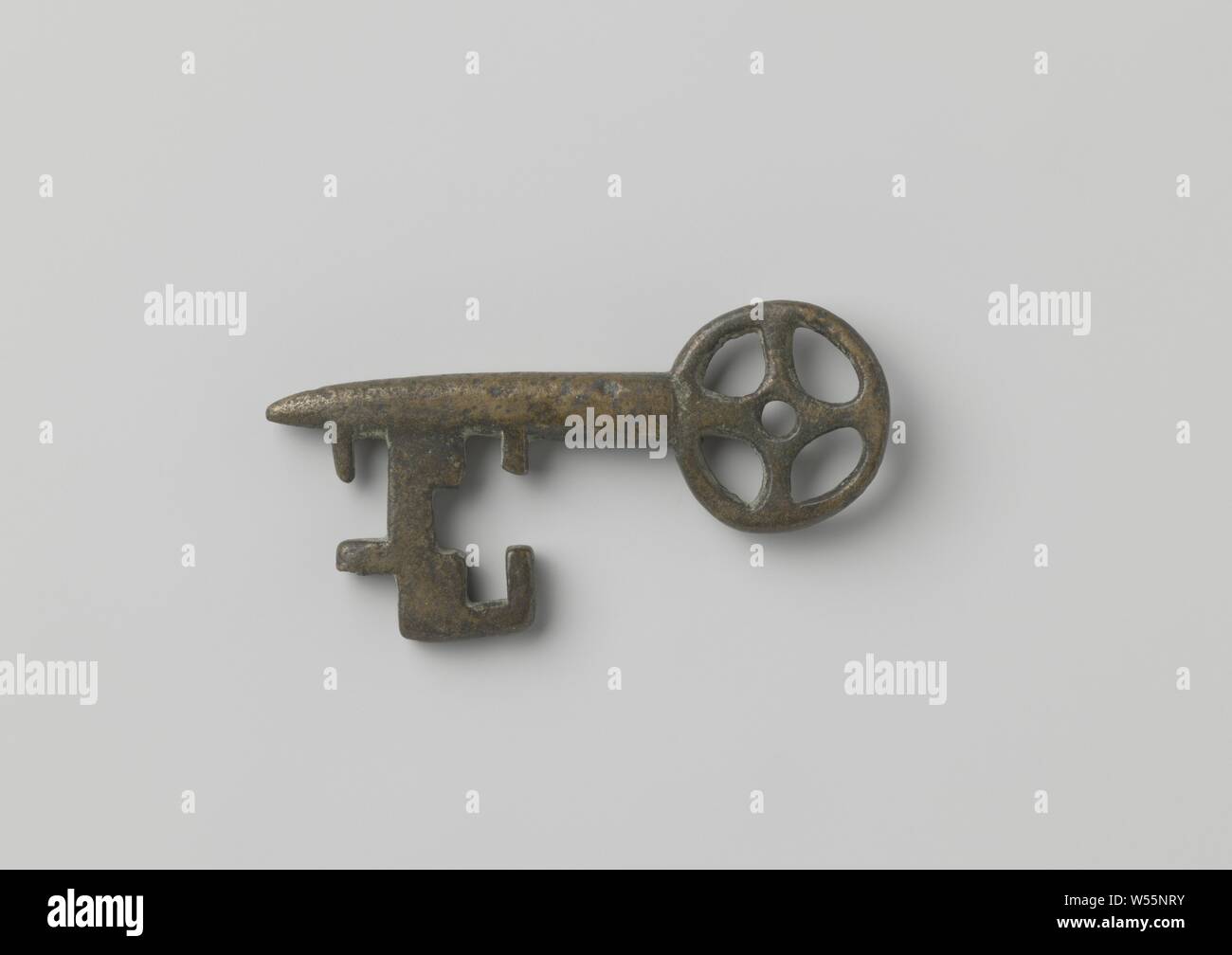 Key with handle similar to a four-spoke wheel and a shaft that ends in ...