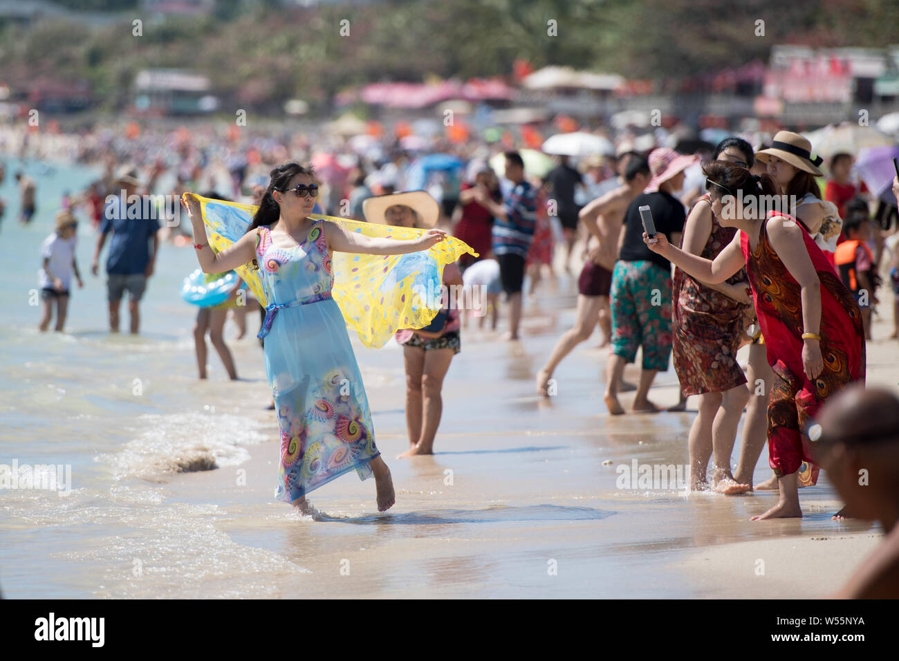 Tourists crowd a beach resort at the Dadonghai scenic spot in Sanya ...