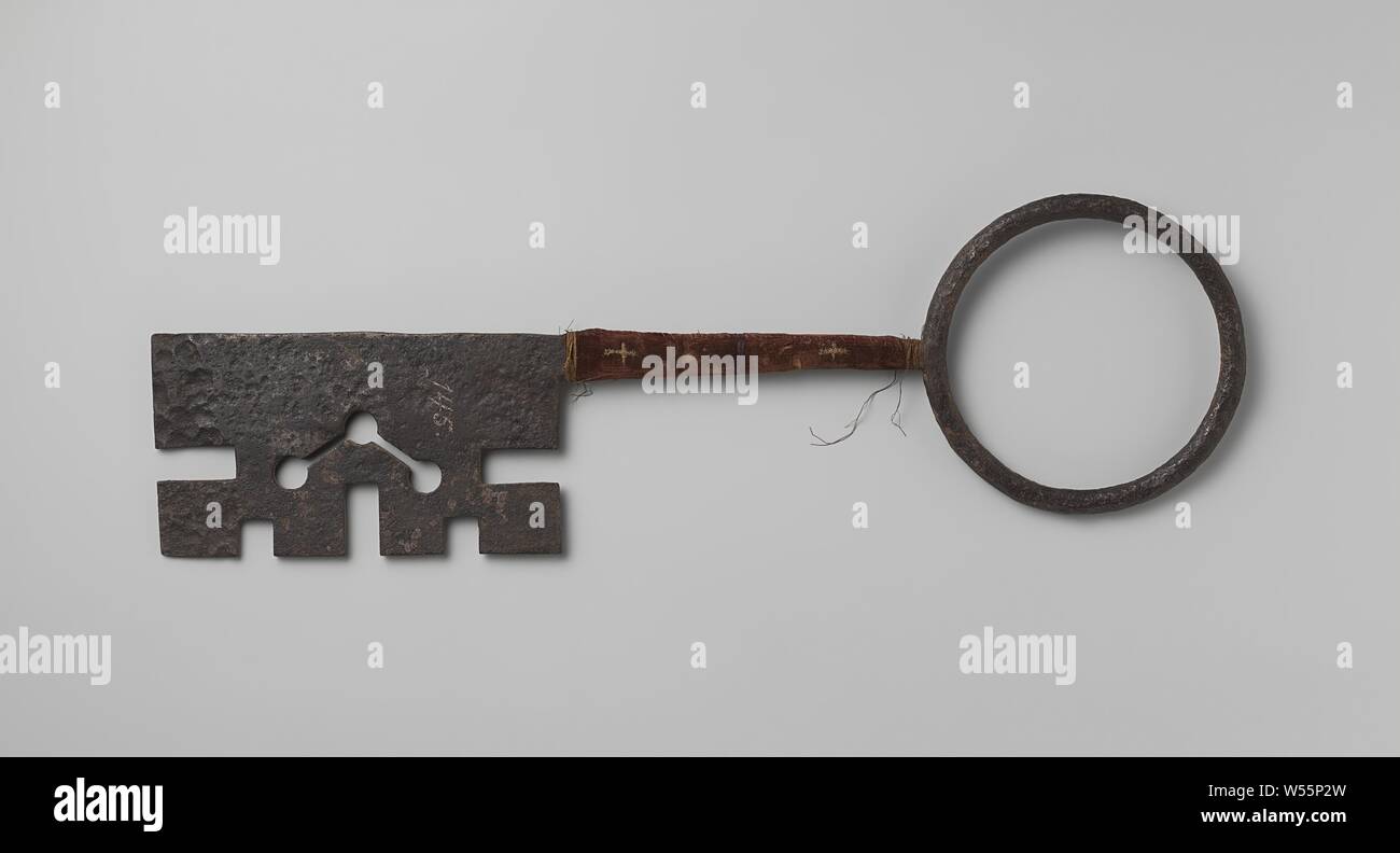 Ceremony key with round, circular eye. The shaft is covered with red ...