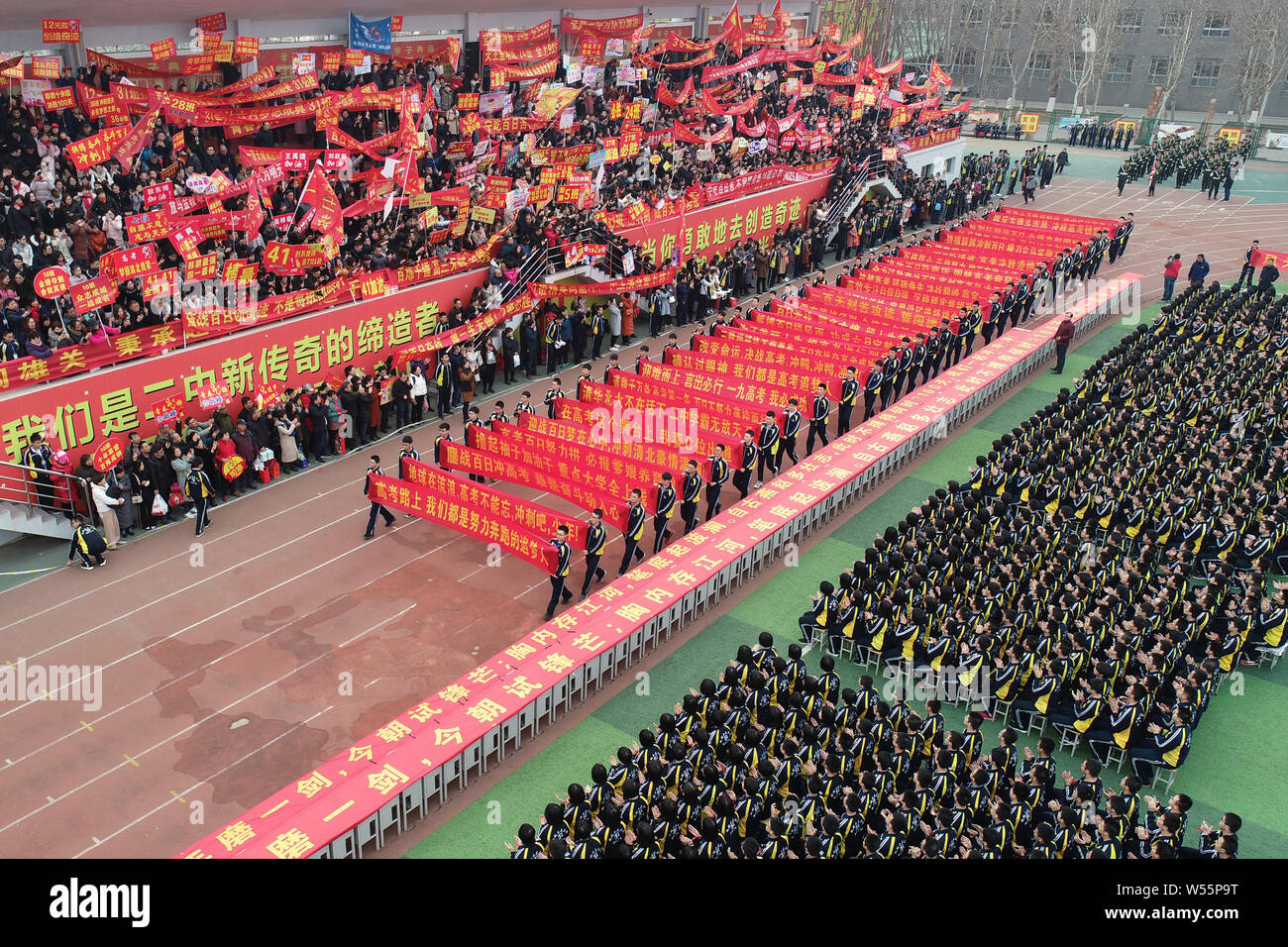 Chinese students queue up in lines during a mass rally for the upcoming ...