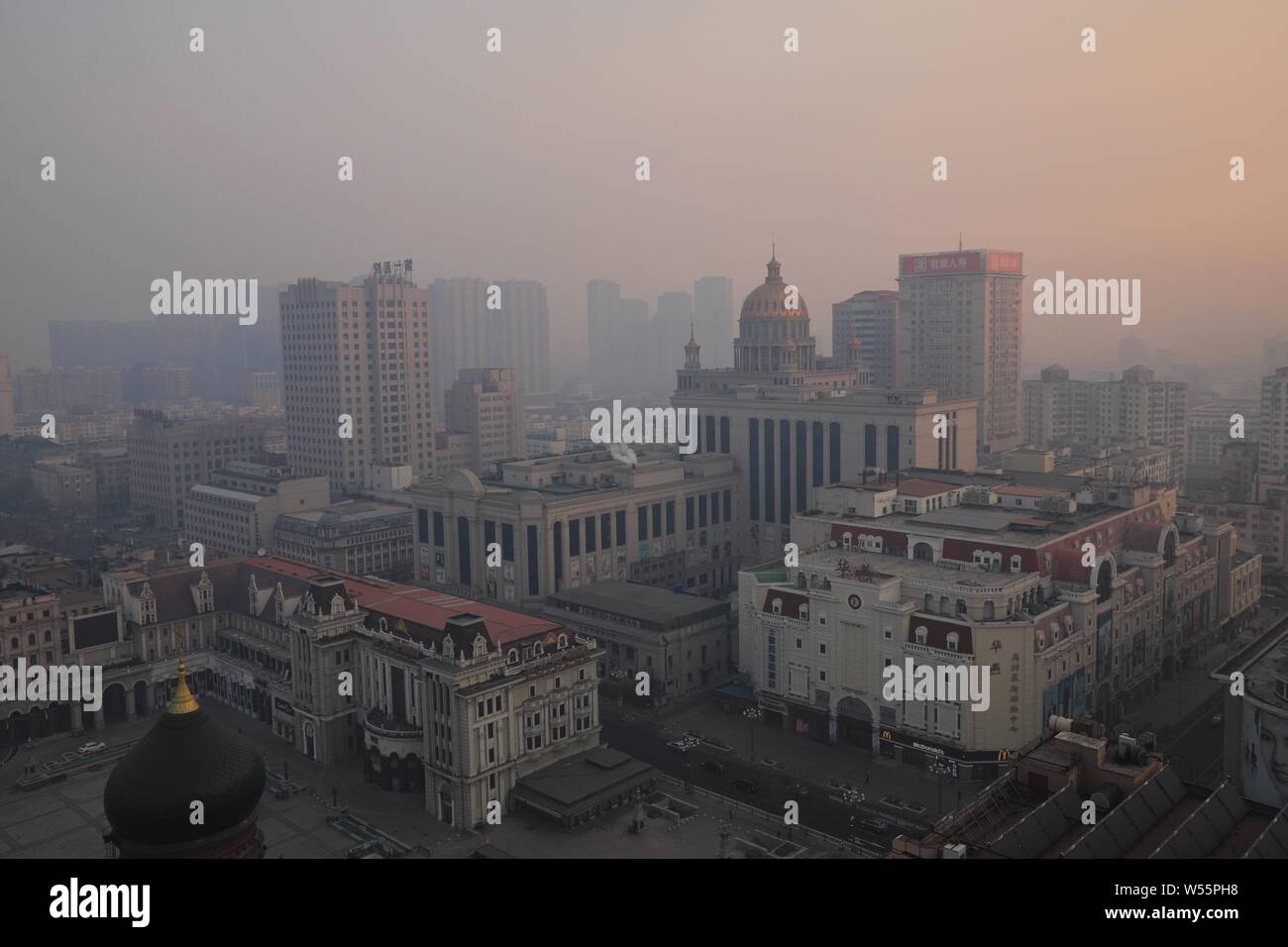 High-rising buildings and skyscrapers are seen vaguely in heavy smog in ...