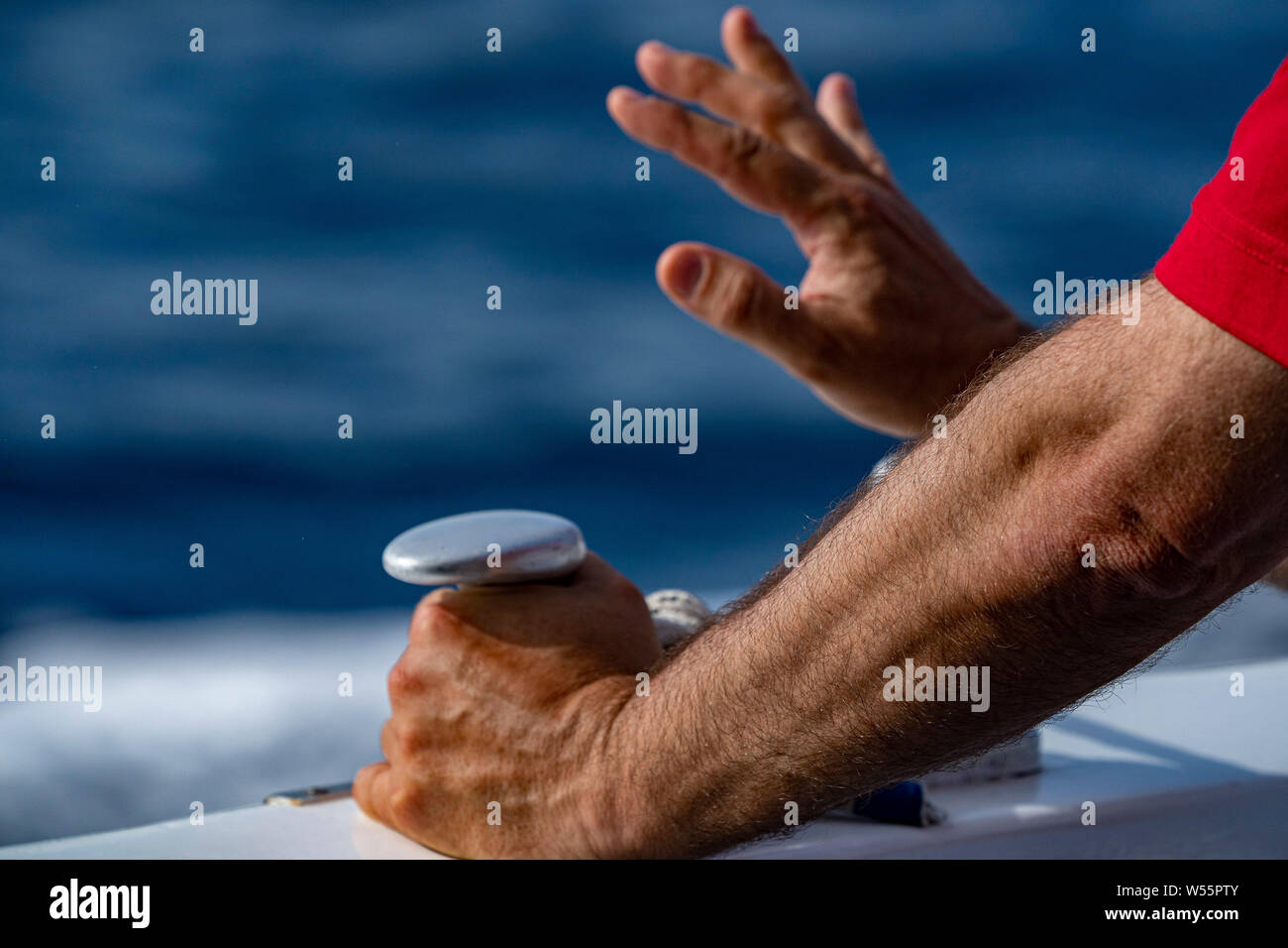 hands of sailor detail on ong boat bollard Stock Photo - Alamy
