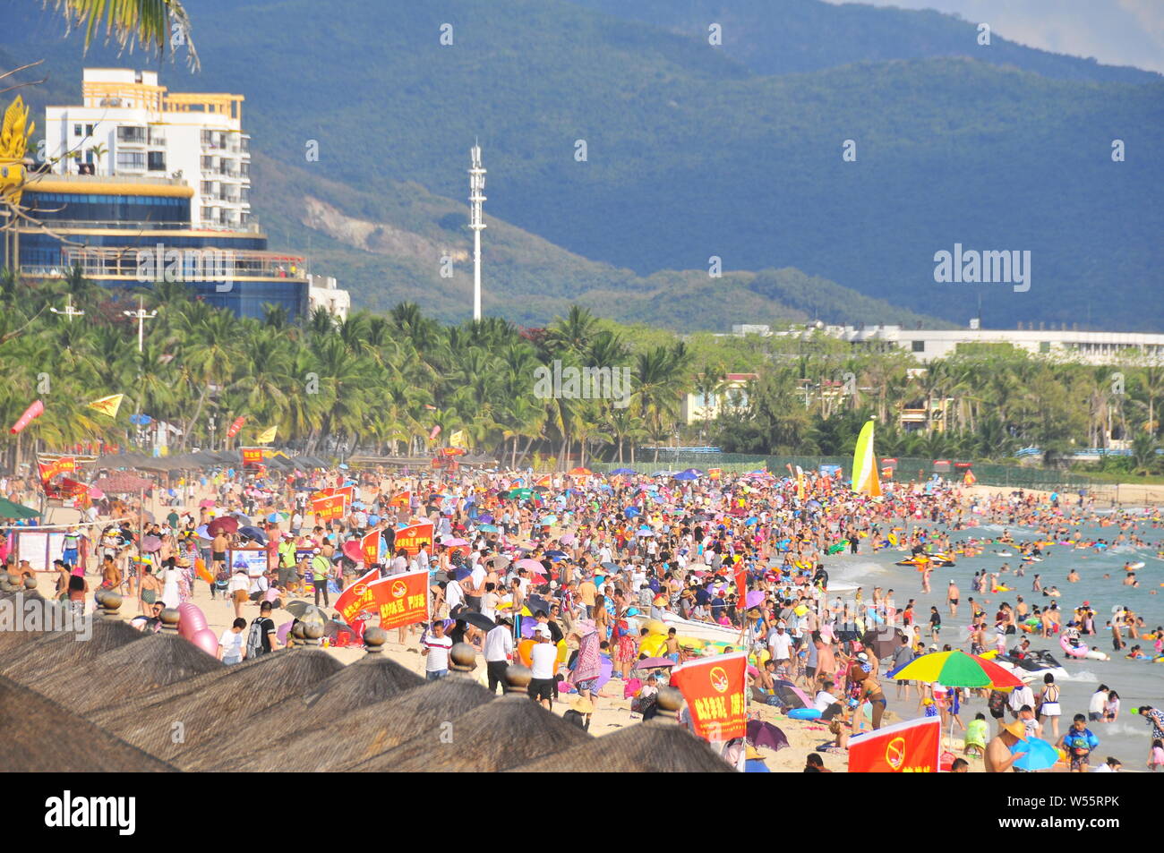 Tourists crowd a beach resort during the Chinese Lunar New Year holiday ...