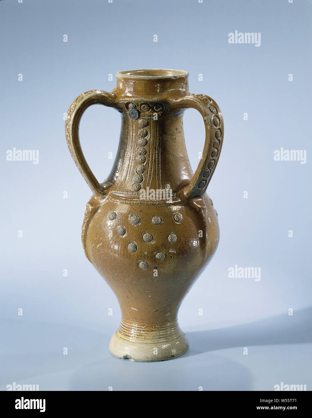Jug with three handles, Stoneware jug on high feet with an egg-shaped ...