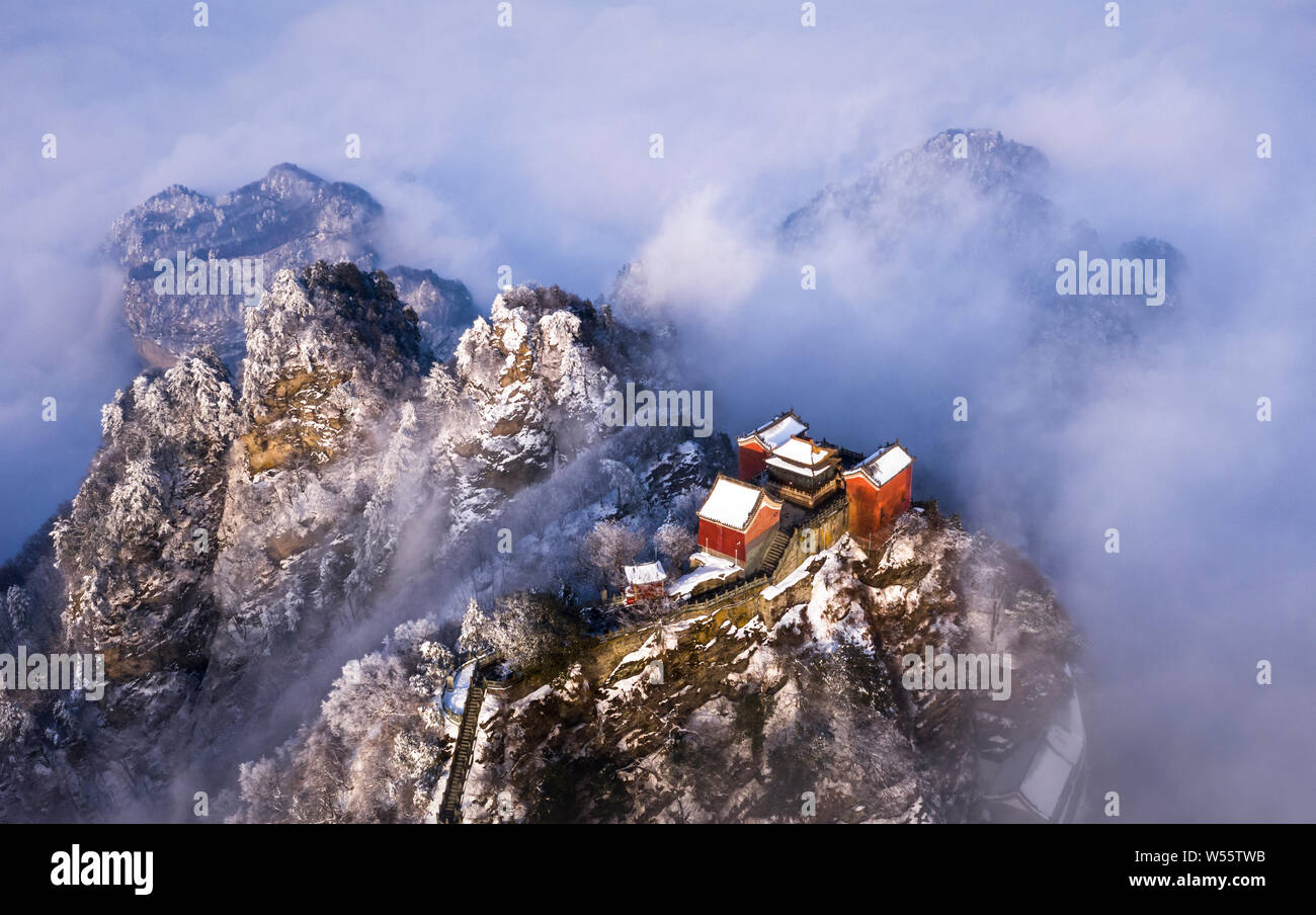 Aerial view of the Wudang Mountains covered with snow in a sea of ...