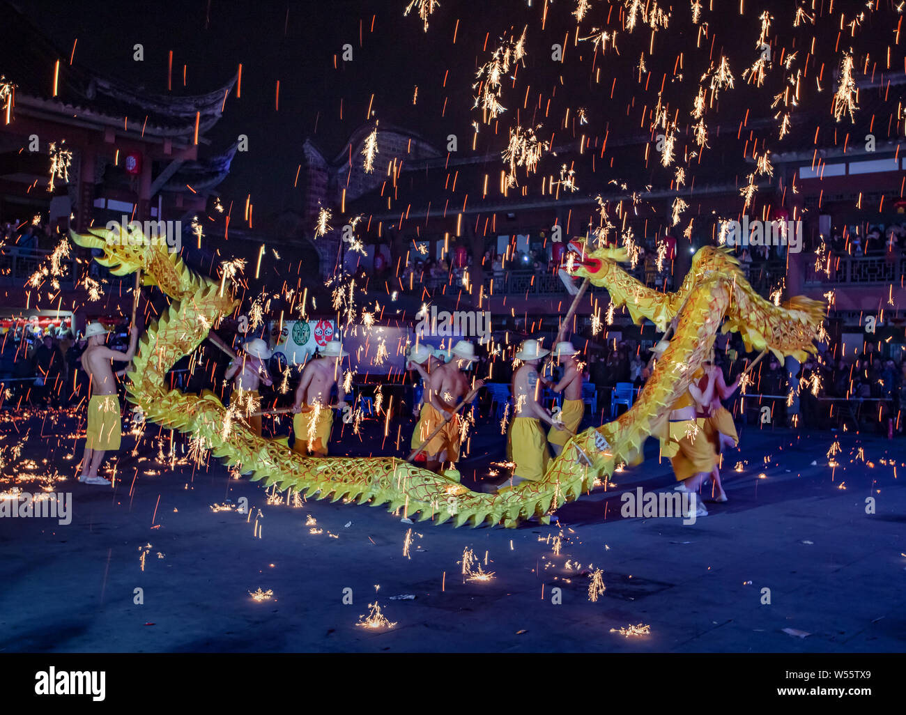 Chinese entertainers perform a fire dragon dance to celebrate the ...