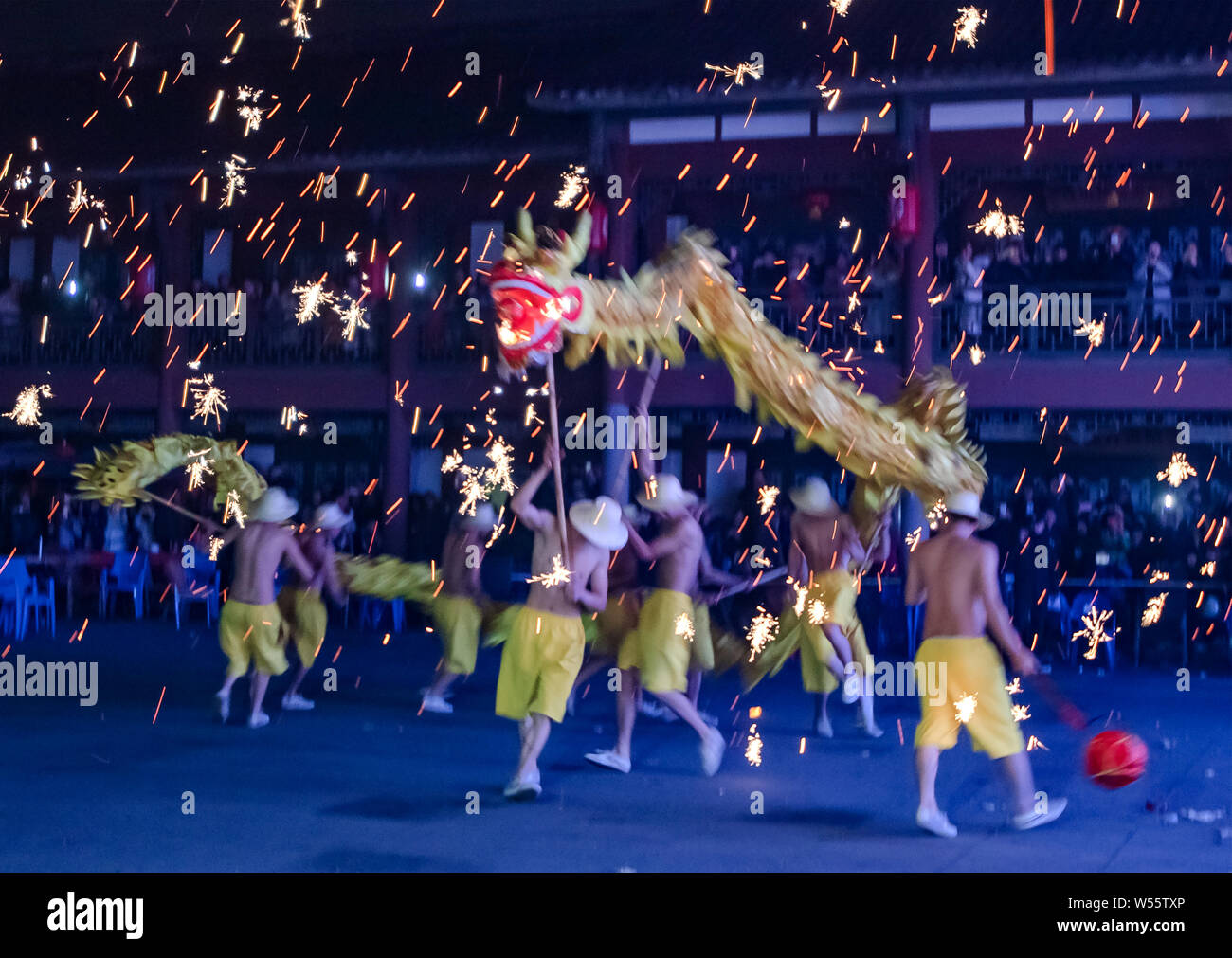 Chinese entertainers perform a fire dragon dance to celebrate the ...