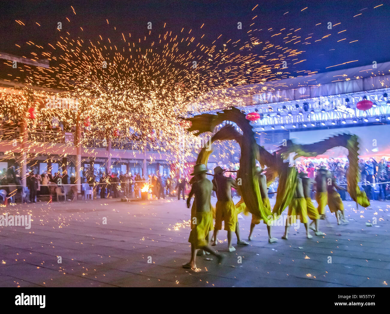 Chinese entertainers perform a fire dragon dance to celebrate the ...