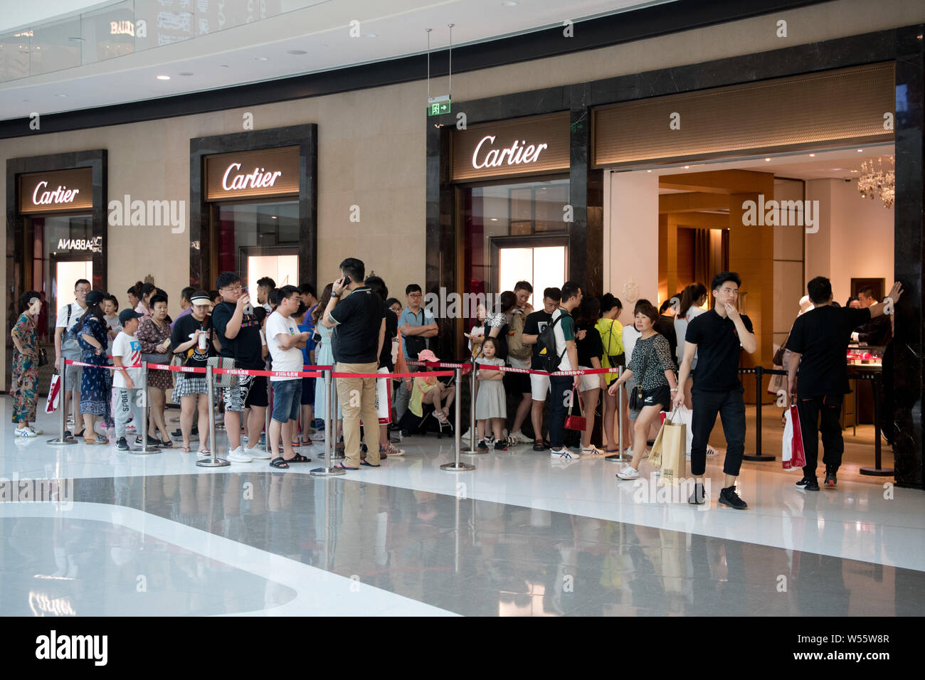 Customers queue up in front of a store of Cartier at the Sanya ...