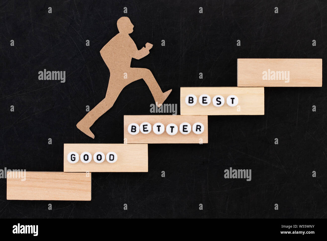 Good - Better - Best paper man climbing the steps to success in a ...