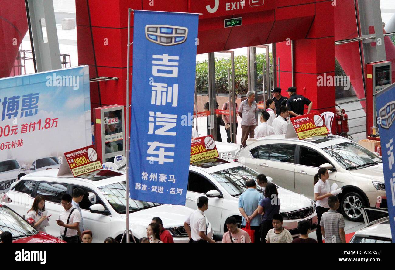 --FILE--People visit the stand of Geely during an automobile exhibition ...