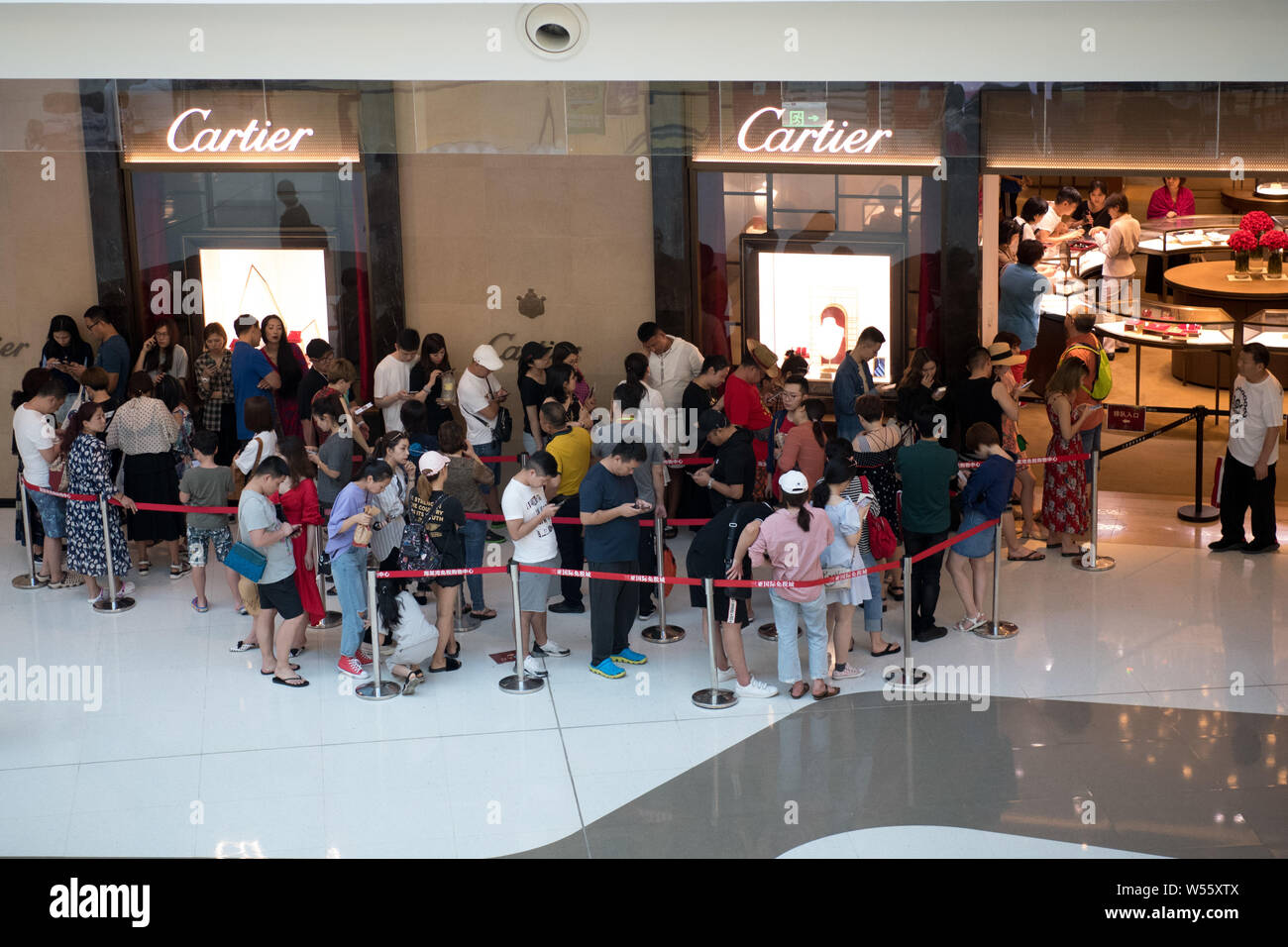 Customers queue up in front of a store of Cartier at the Sanya ...