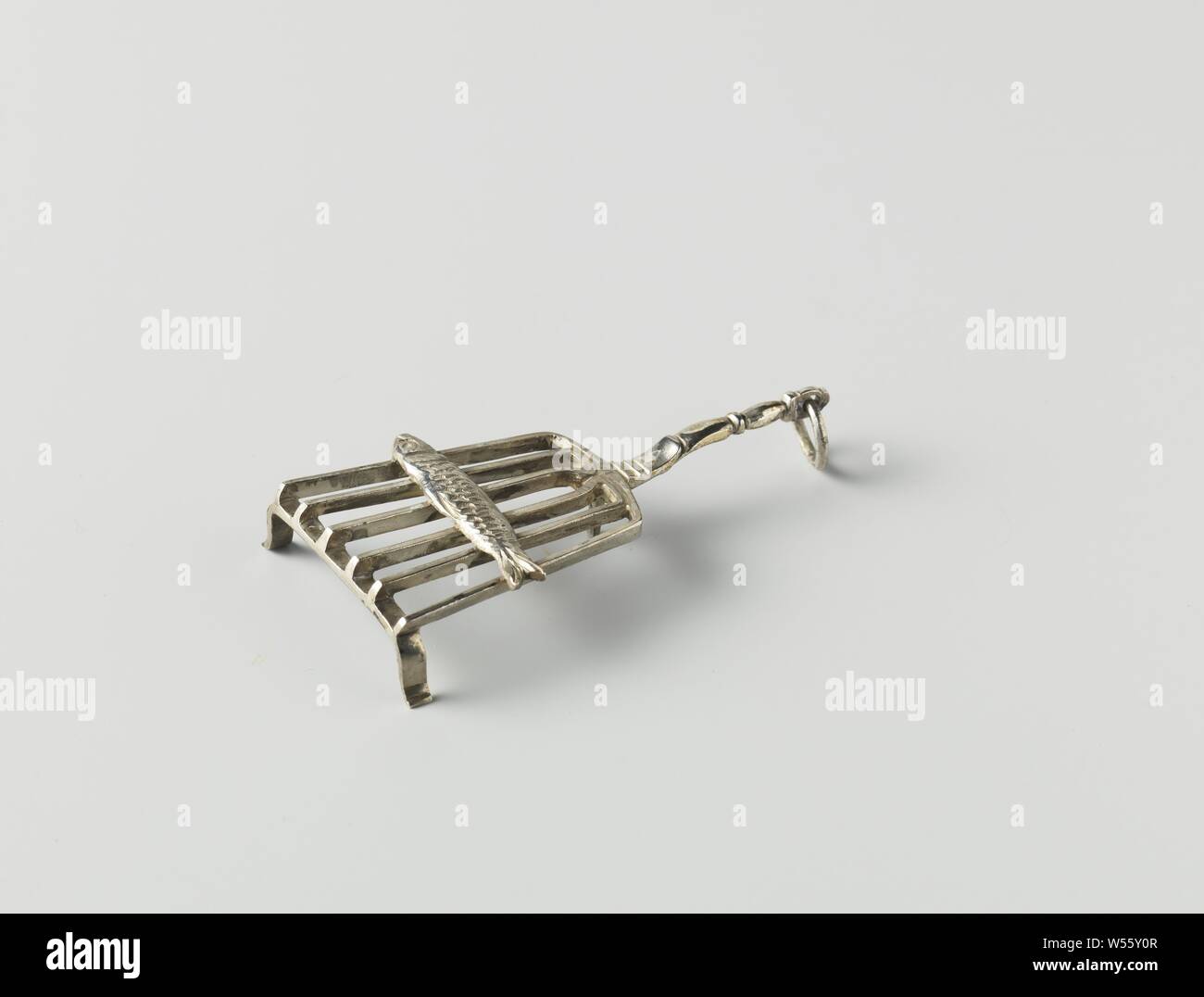 Fish grid, Fish grid on three legs and a profiled handle with a ring at ...