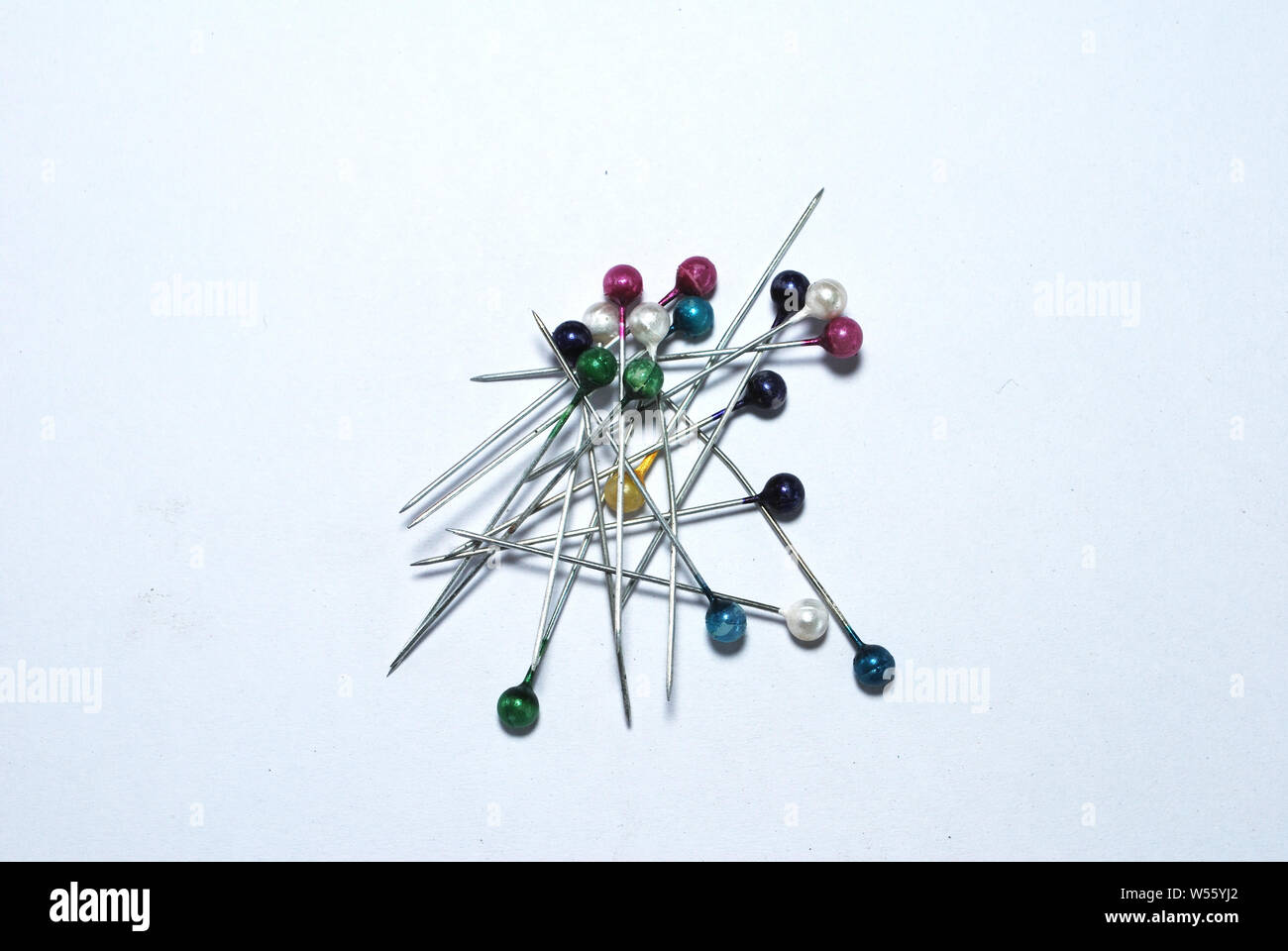 Many colorful pins isolate on white background Stock Photo - Alamy