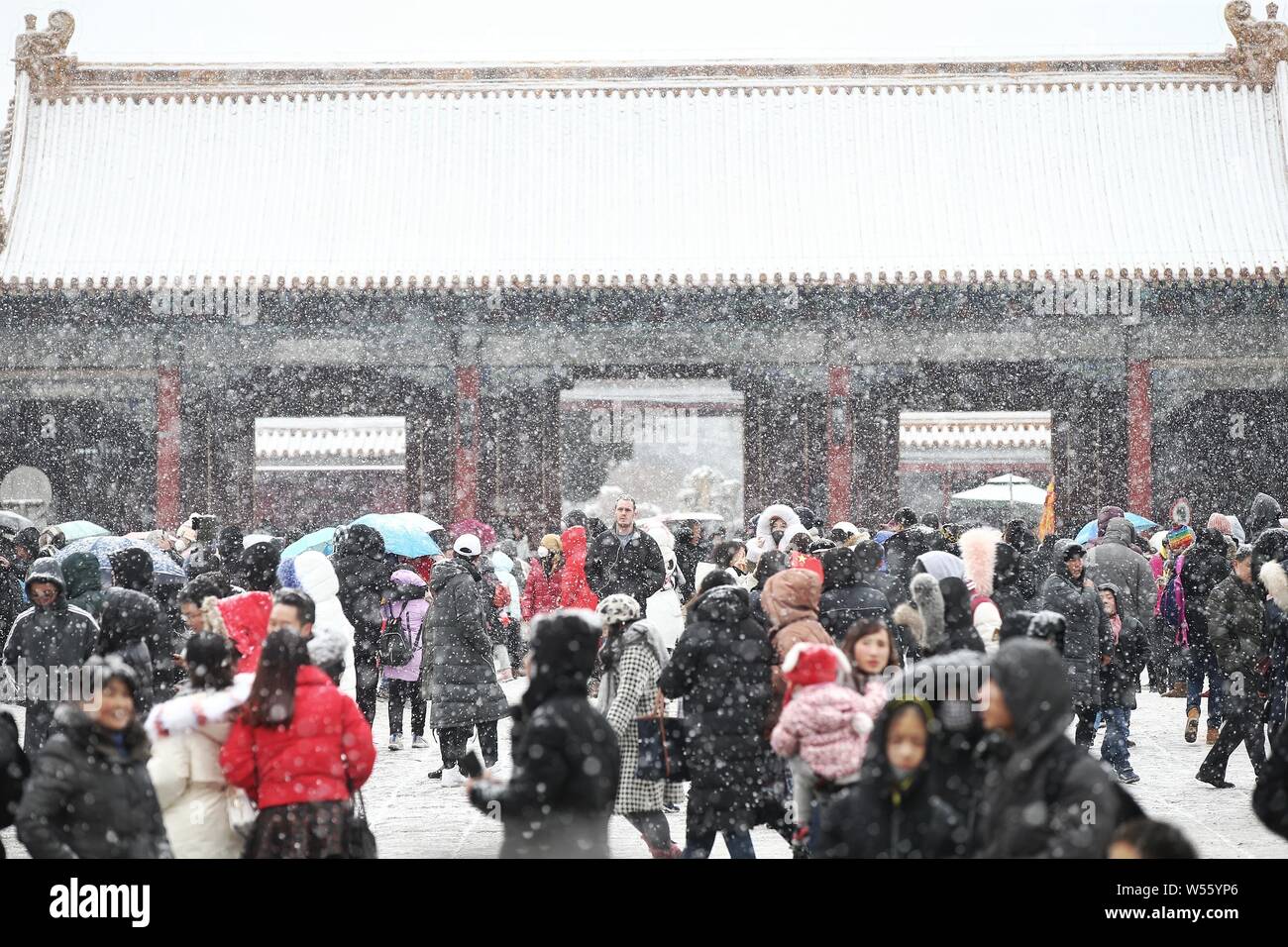Tourists visit the Palace Museum, also known as the Forbidden City, in ...