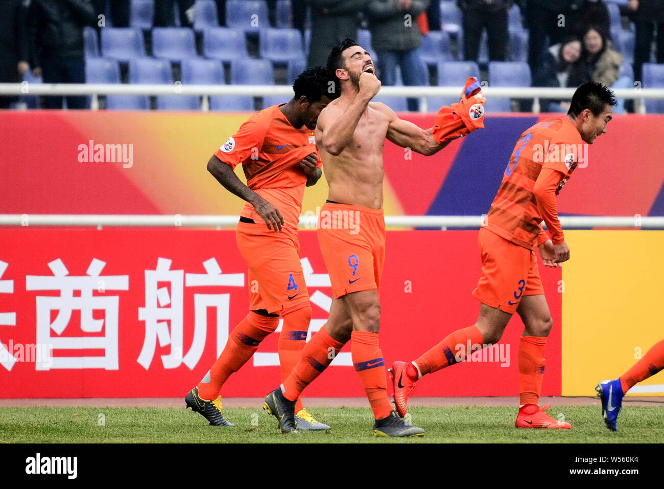 Italian football player Graziano Pelle, center, of China's Shandong Luneng Taishan F.C ...