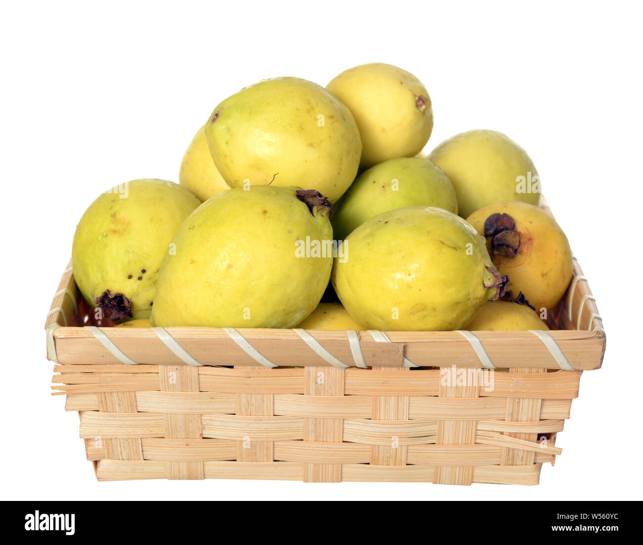 many guava fruit in the basket isolated on white Stock Photo - Alamy