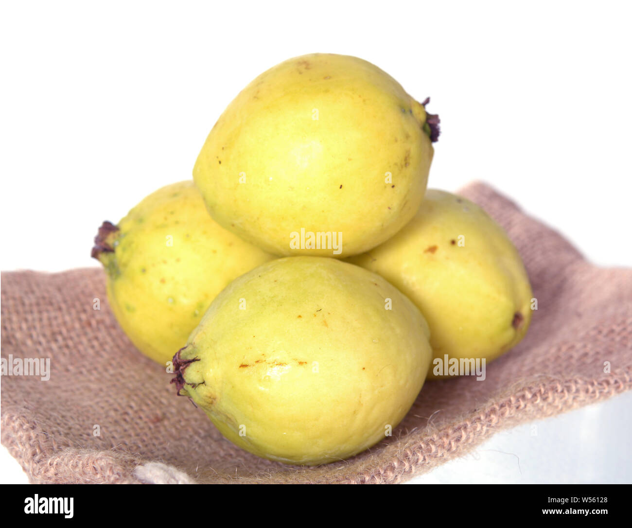 many guava fruit in the basket isolated on white Stock Photo - Alamy