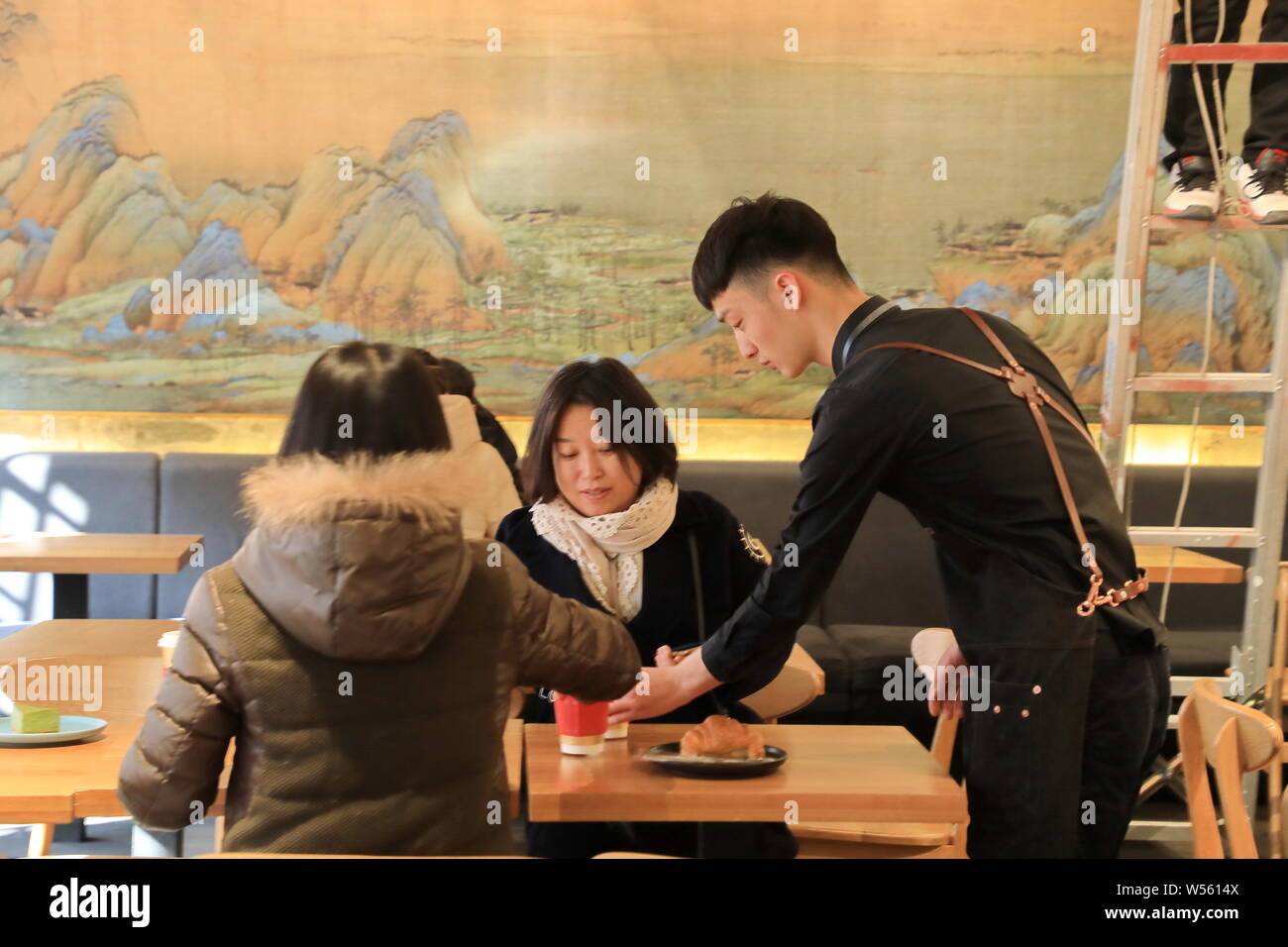 Chinese customers enjoy coffee at the Corner Tower Cafe near the Palace ...