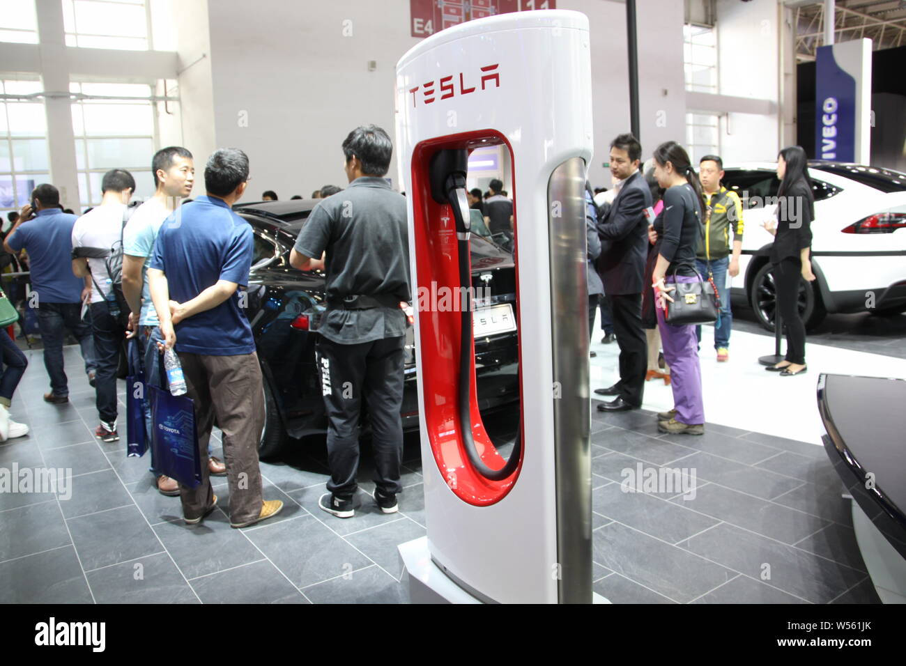--FILE--People visit the stand of Tesla during the 14th Beijing ...