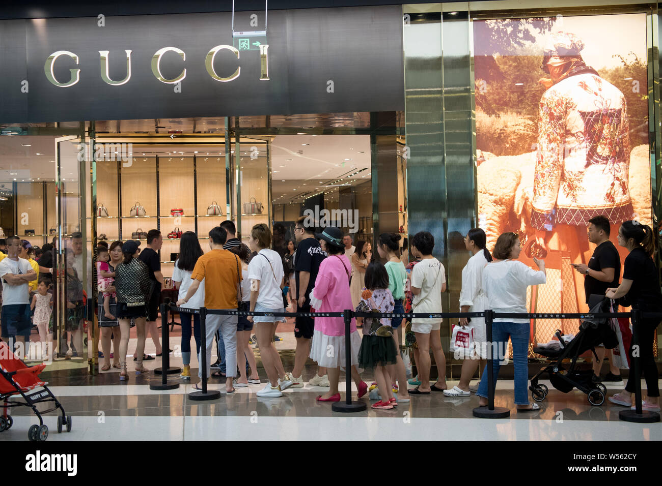 Customers queue up in front of a store of Gucci at the Sanya ...