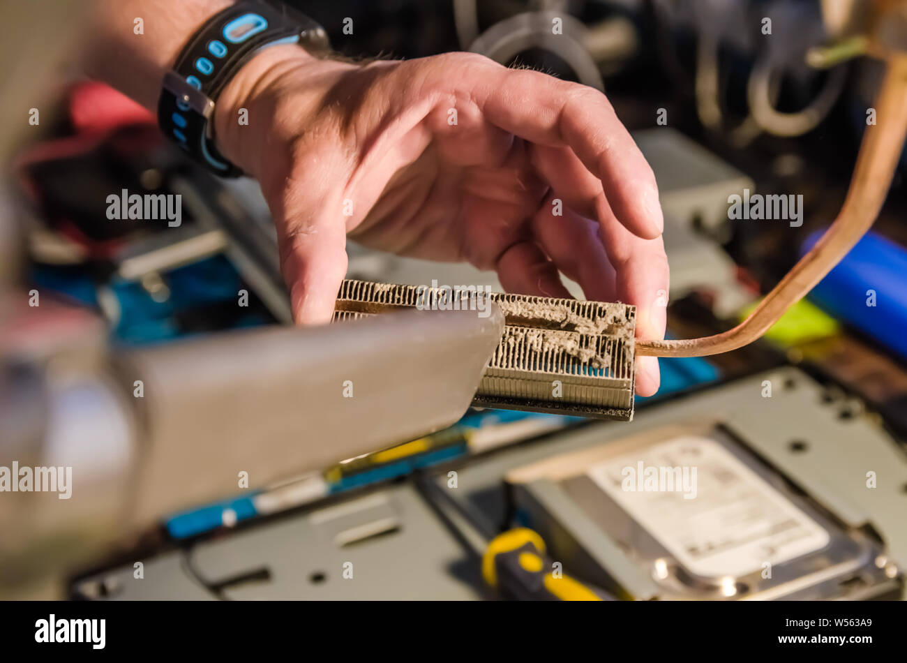 Technical support worker vacuums processor radiator from dust Stock ...