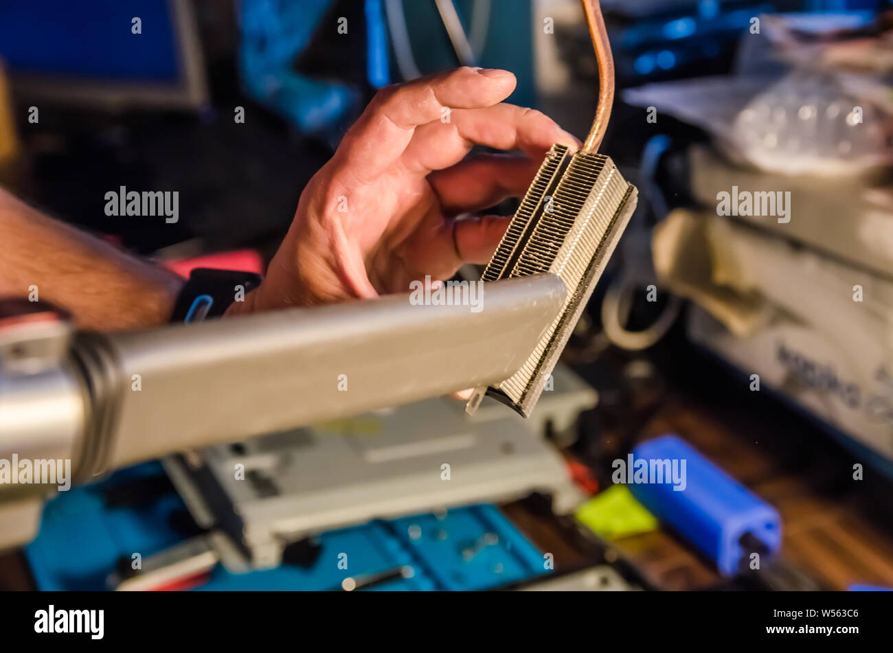 Technical support worker vacuums processor radiator from dust Stock ...