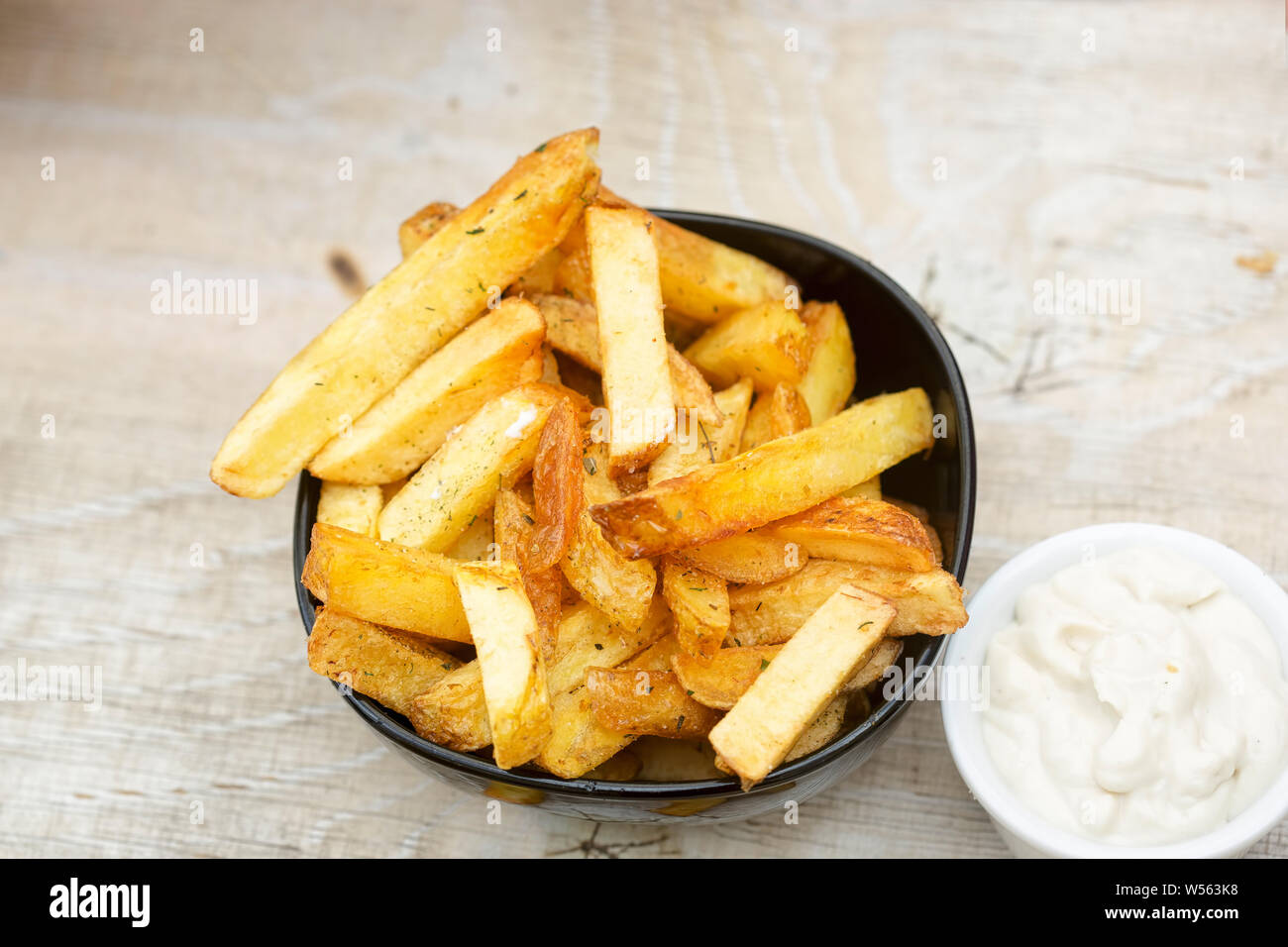 Bowl of potato chips fries with ginger dip Stock Photo - Alamy