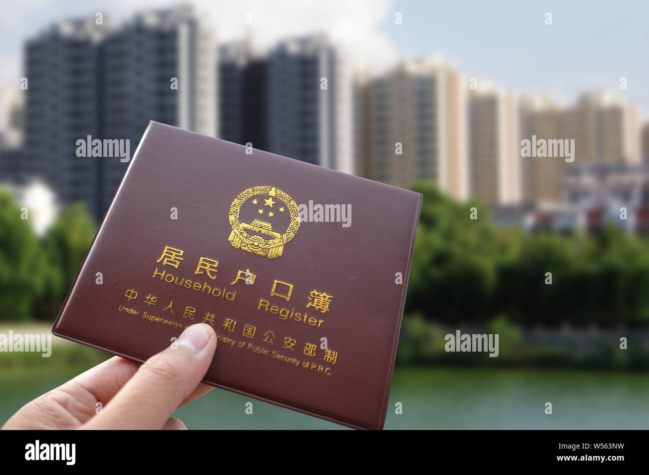 --FILE--A local Chinese resident shows his household register, also ...