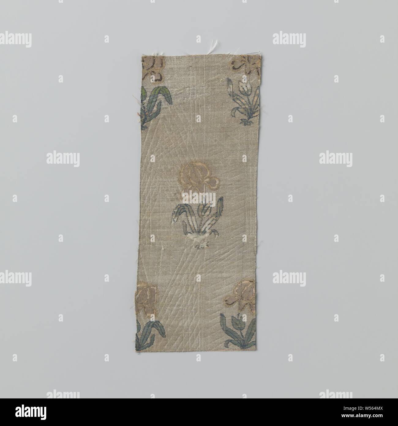 Fragment of embroidered silk with pattern of flowers in diamonds ...