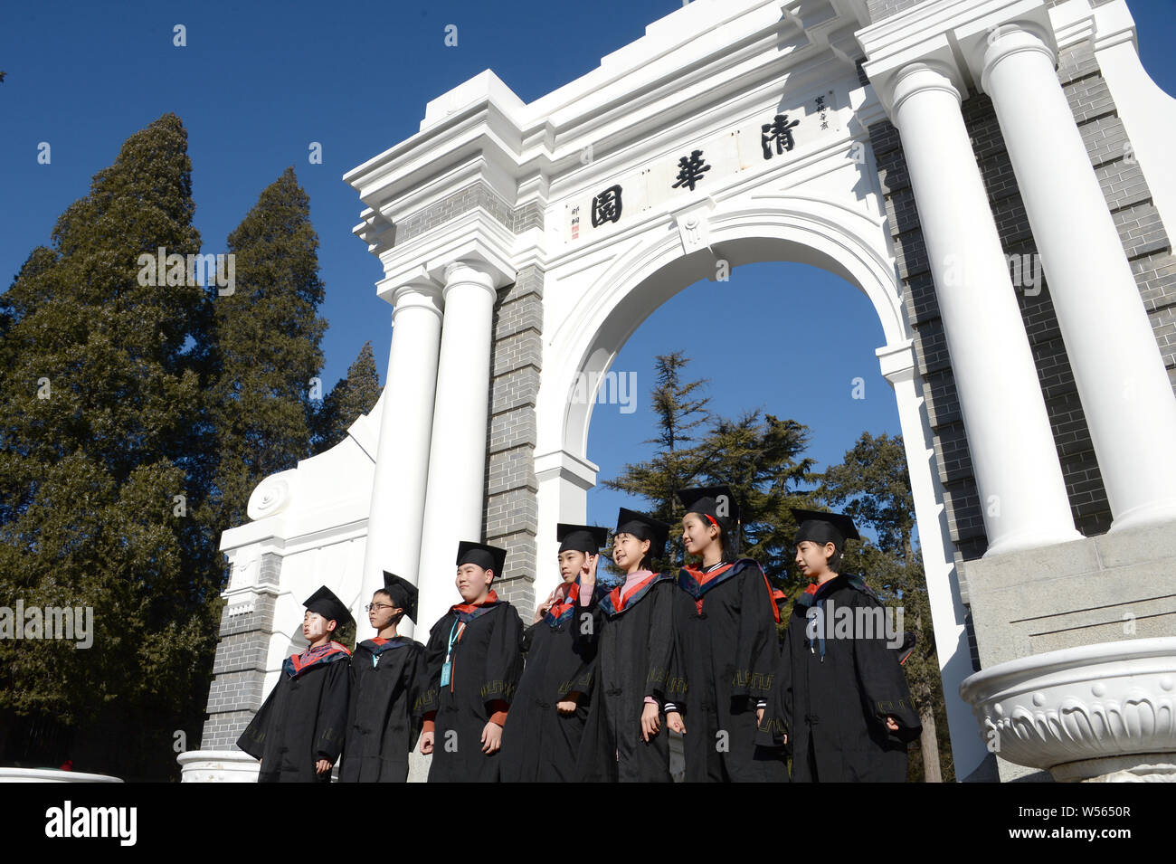 --FILE--Chinese students pose in front of the symbolic Second Gate of ...