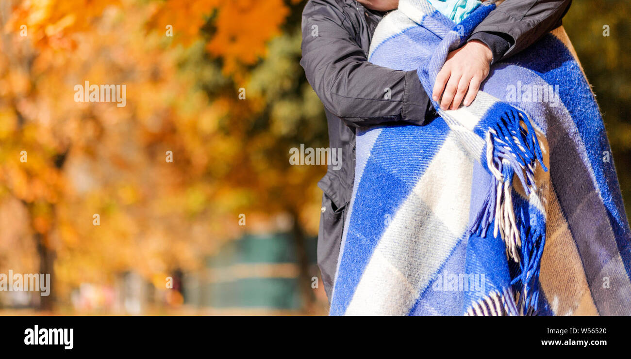 Photo of Caring man covers a woman with a rug Stock Photo - Alamy