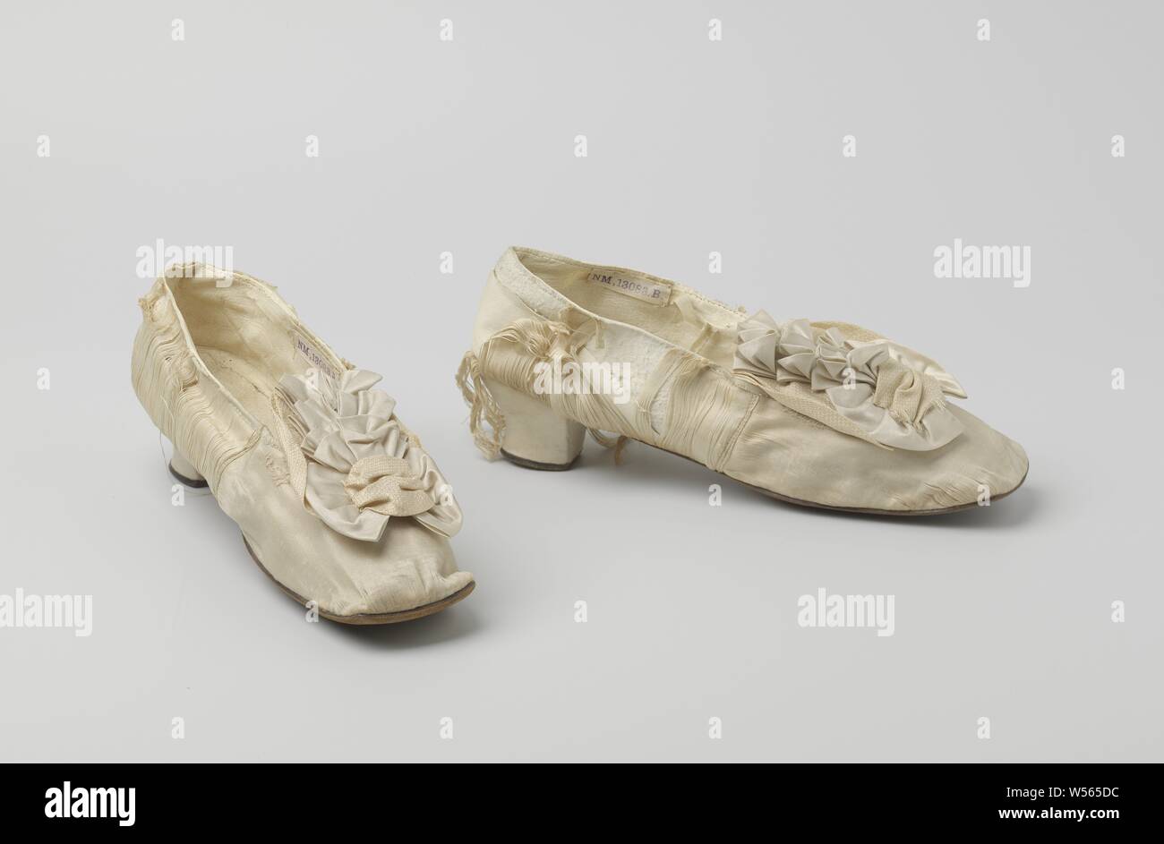 White satin ball shoe with bows on the front shoe, square toe and three ...