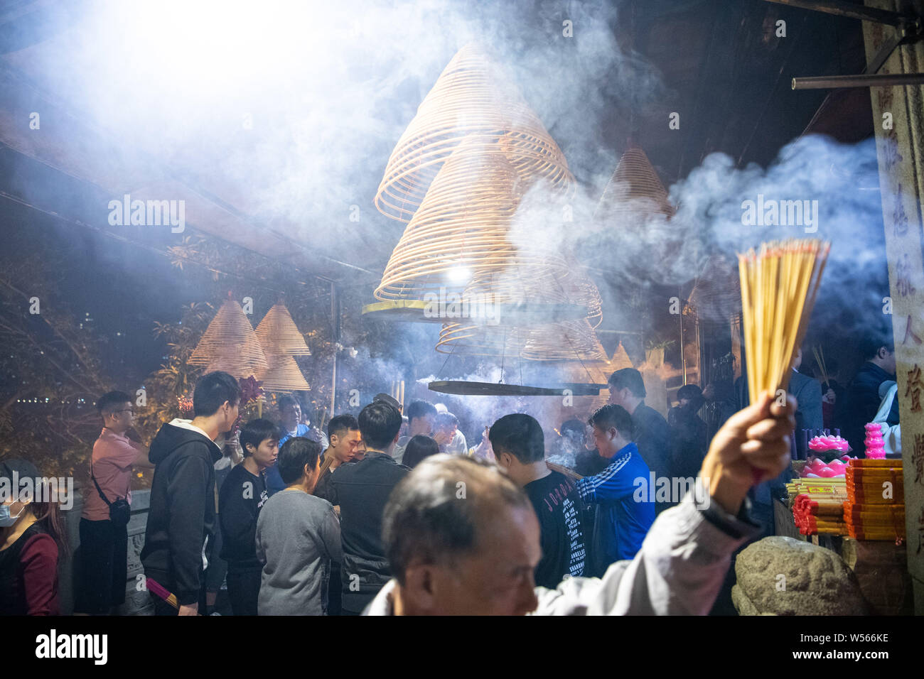 Chinese worshippers burn incense sticks to pray for good luck before ...