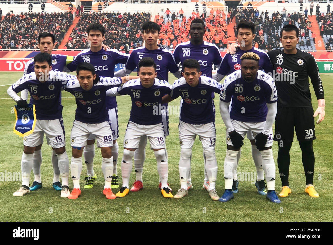 Players of the starting line-up of Vietnam's Hanoi FC pose for photos ...