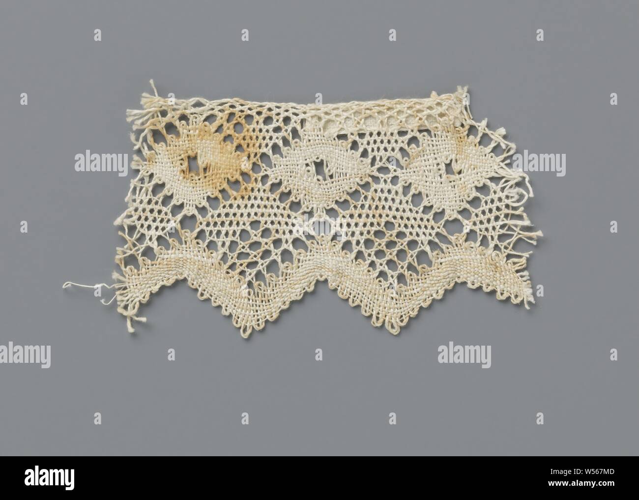 Bobbin lace strip with a row of diamonds and a wavy scalloped edge ...
