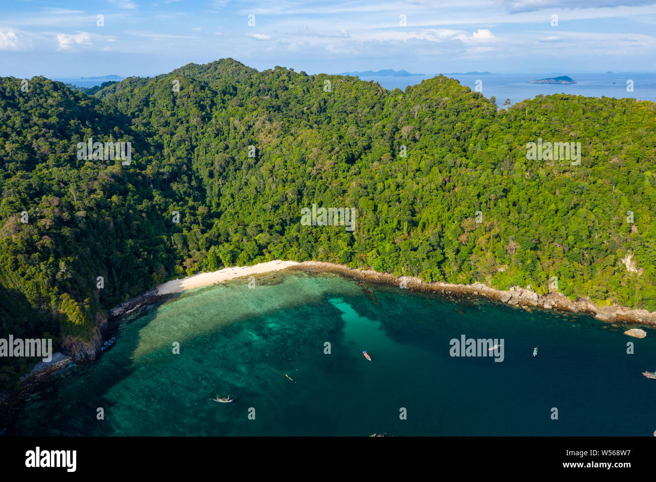 Aerial view of a fleet of fishing boats of a small tropical island in ...