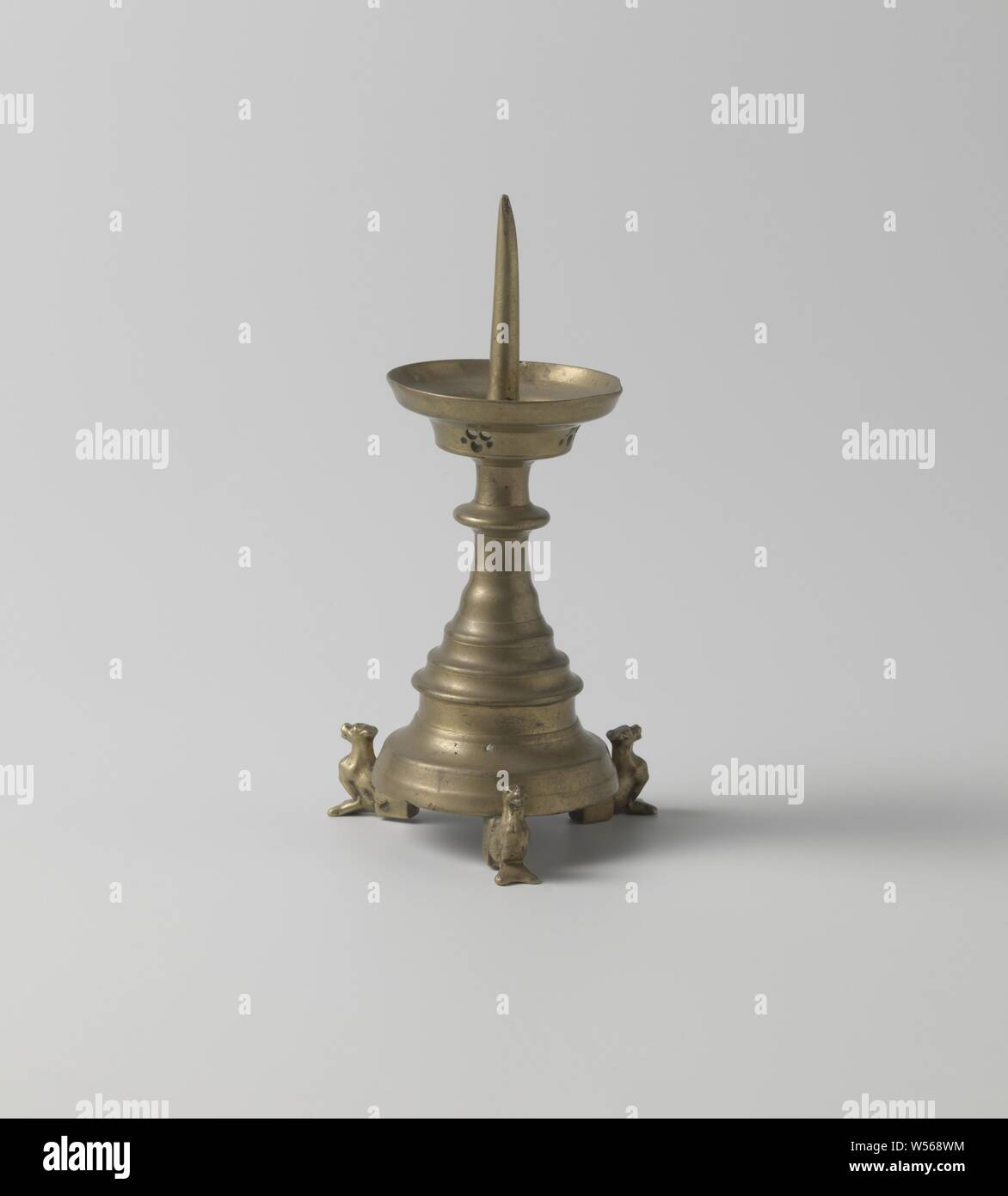 Candlestick carried by three fantasy animals. The object is composed of ...