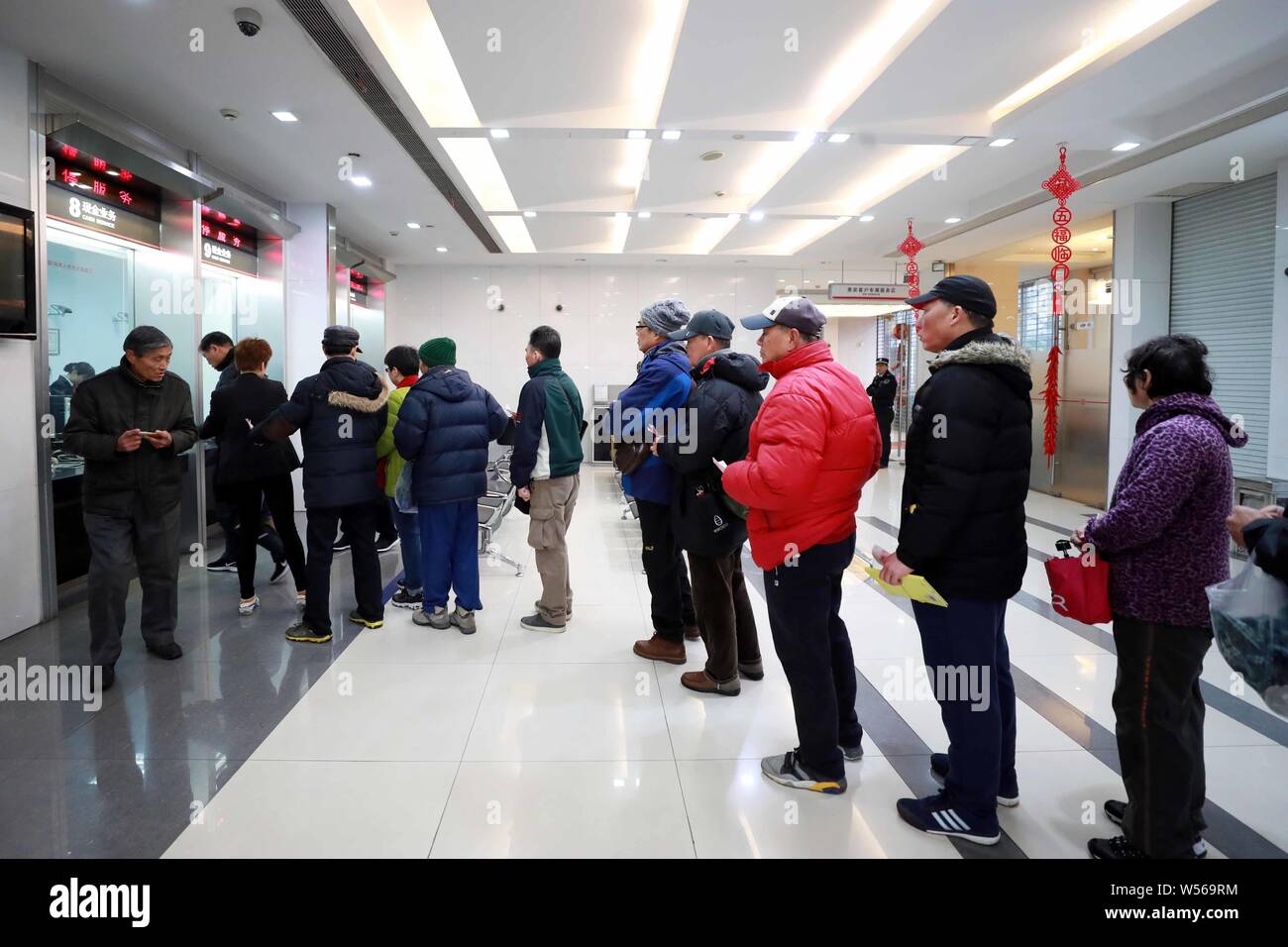 Local Chinese residents queue up in a branch of Industrial and ...
