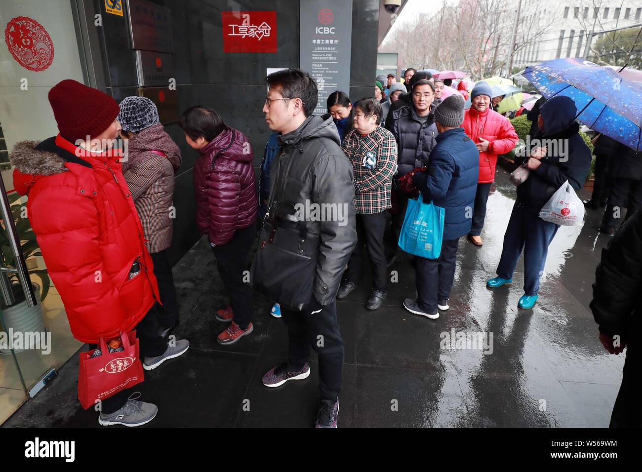 Local Chinese residents queue up outside a branch of Industrial and ...