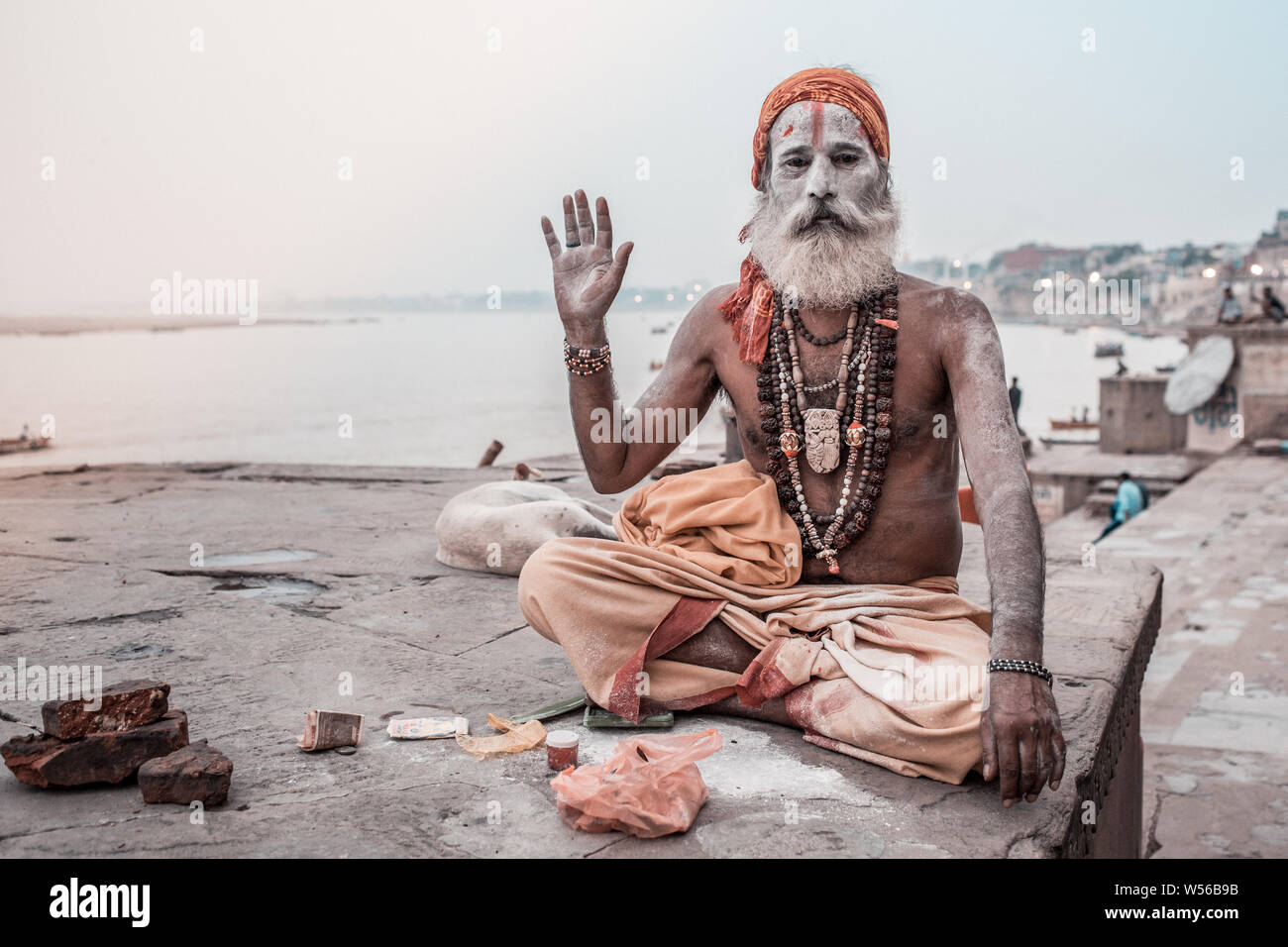 A Sadhu sitting next to the Ganges river in Varanasi, India Stock Photo ...