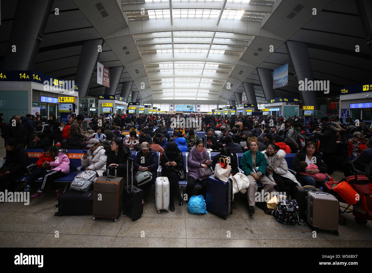 Passengers wait for their trains during the Spring Festival travel rush ...