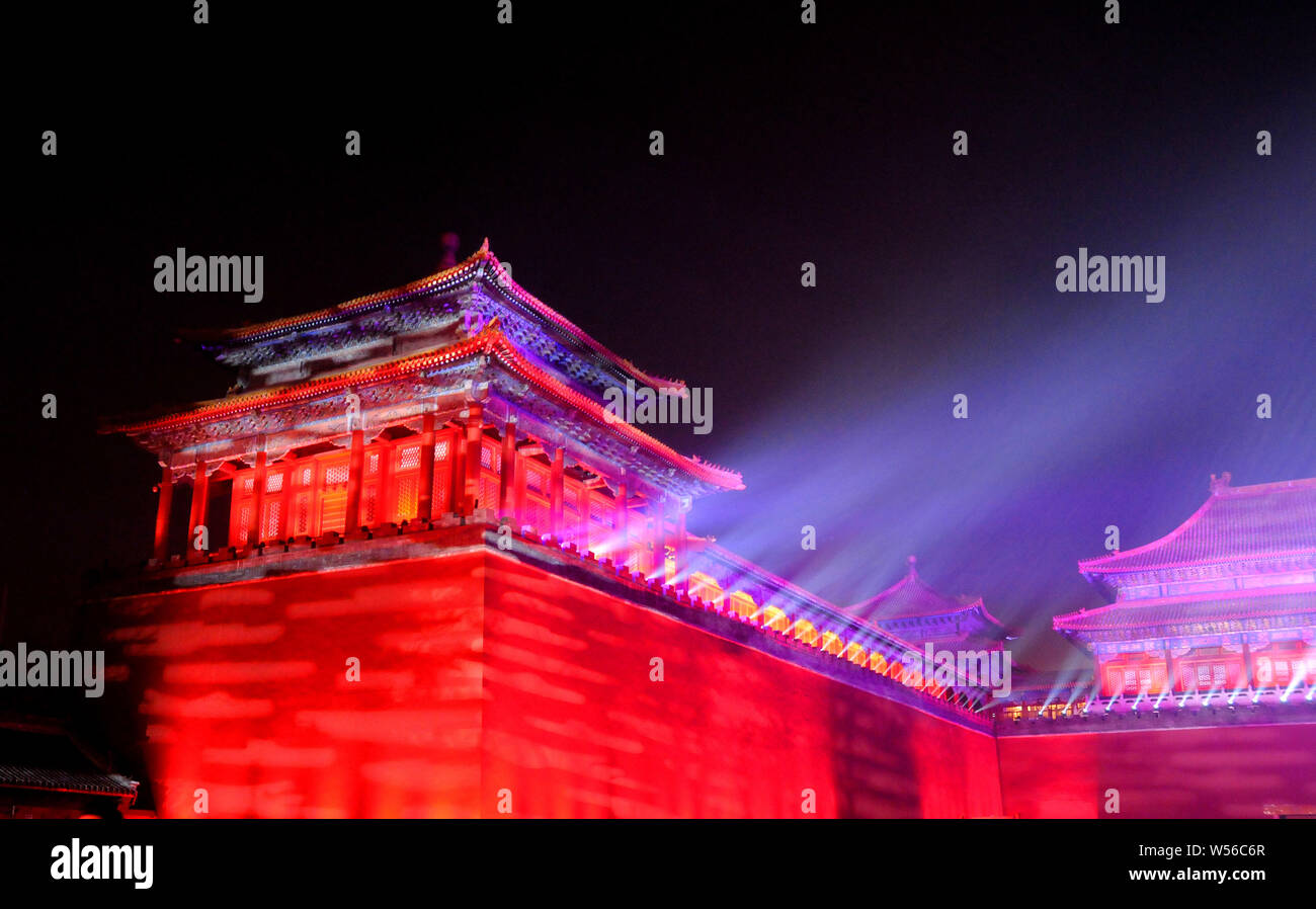 The Palace Museum, also known as the Forbidden City, is illuminated by colorful lights during a ...