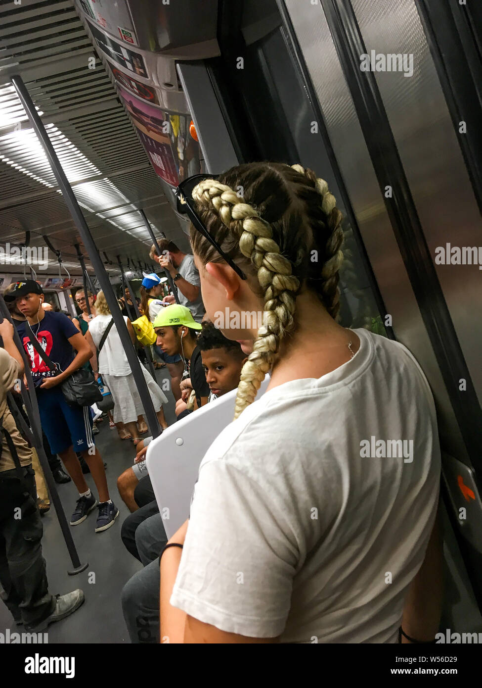 A girl with blonde braids stands in a metro train, Lyon, France Stock ...