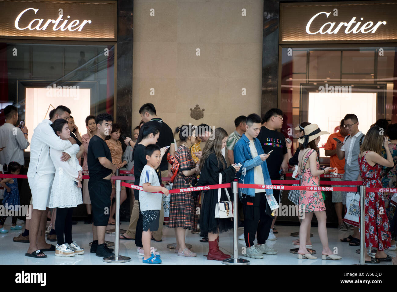 Customers queue up in front of a store of Cartier at the Sanya ...