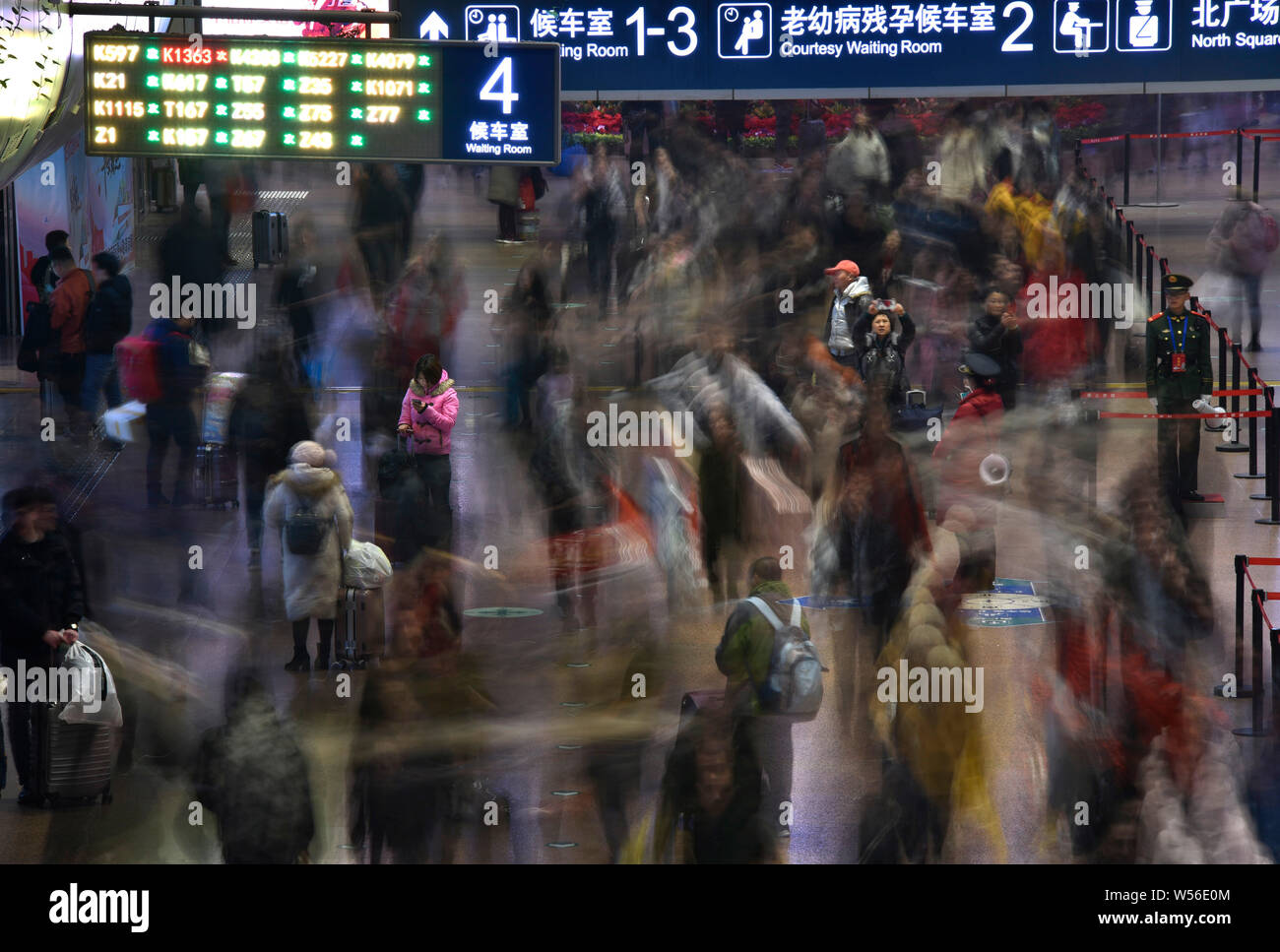 Passengers wait for their trains during the Spring Festival travel rush ...